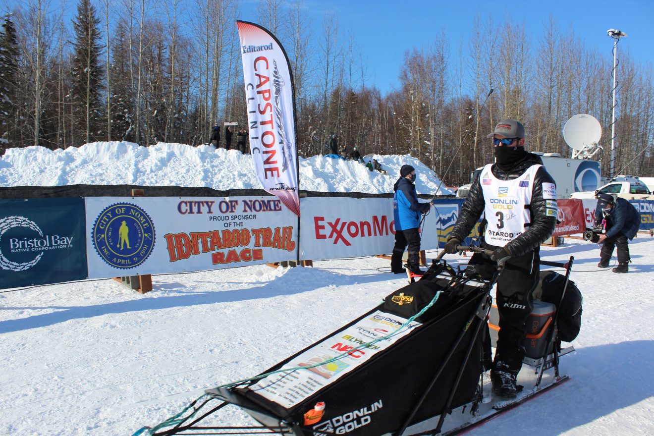 Veteran Iditarod musher Pete Kaiser scratches at McGrath (S) checkpoint ...